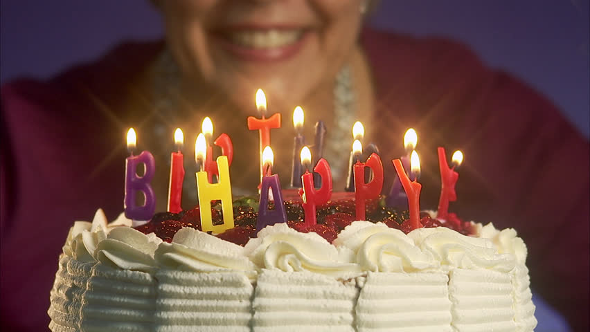 Woman Blowing Out The Candles On A Birthday Cake Stock Footage Video
