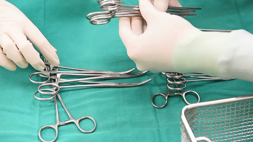 Shot Of Doctor Setting Surgical Instruments And Tools On A Table For A ...